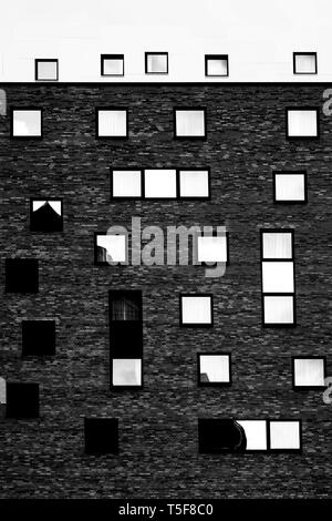 Black building with strange asymmetric windows Stock Photo - Alamy