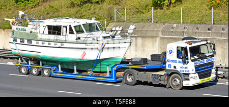 Low loader articulated trailer & hgv lorry truck loaded with wide ...