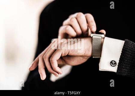 Businessman checking time on his smartwatch Stock Photo - Alamy