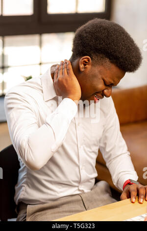 Upset and gloomy african american man in beanie, pointing fingers up ...