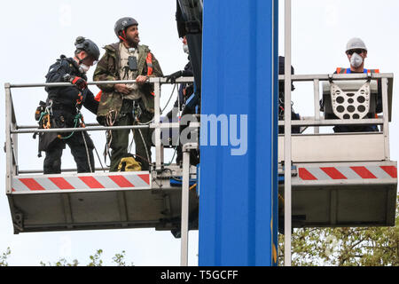 Police officers from the Protester Removal Team work to free a Just ...