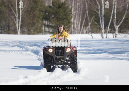 Woman riding snowmobile in snowy alps during winter Stock Photo ...