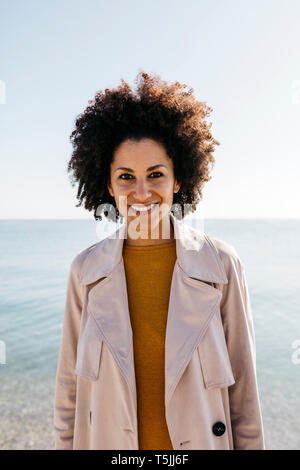 Portrait of a smiling woman by the sea Stock Photo - Alamy