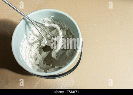 Bucket with ready putty and drill mixer Stock Photo - Alamy
