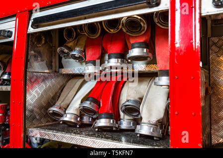 the fire hoses are in the fire truck compartment Stock Photo - Alamy