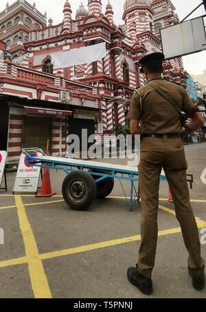 A Sri Lanka military police officer walks past the destroyed car of Maj ...
