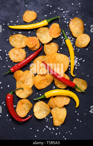 Red and black potato chips with salt, chili pepper. Isometric drawing ...