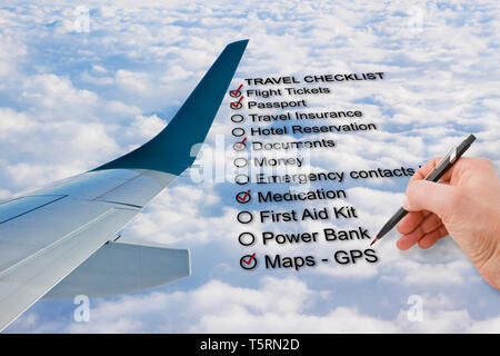 Hand write a Travel Checklist over a cloudy sky and airplane - concept ...