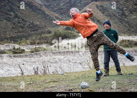 Men playing dego (Traditional Bhutanese game), Chozo, Lunana Gewog ...