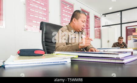 Thai Police Officer (Police Sergeant Major) on duty at a local Thai ...