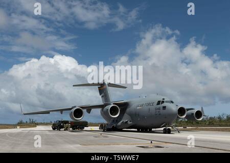 U.S. Air Force Airmen pump fuel from a C-17 Globemaster to a fuel truck ...