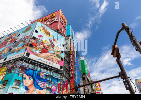 Anime-style billboards and Pachinko E-Space Nittaku sign on building ...