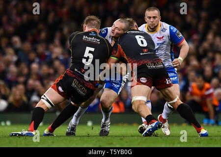 Ken Owens of Scarlets is tackled by Matthew Screech and George Nott of ...