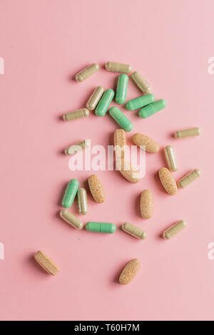 top view of many colorful pills and capsules on green background Stock ...