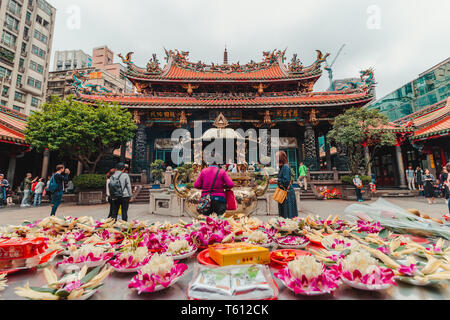 Foods and Flowers placed by visitors at Longshan Temple, one of the ...