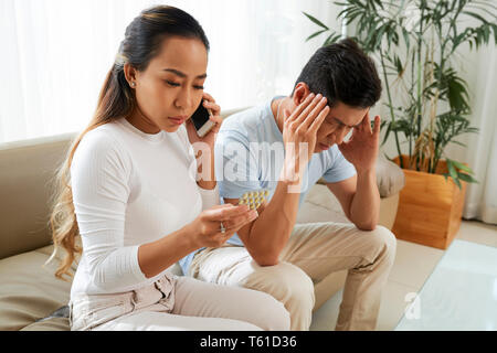 Asian doctor woman talking phone call explaining medical advice patient ...