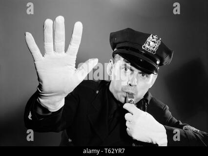 A police officer's white gloved hand searches for a name on the wall ...