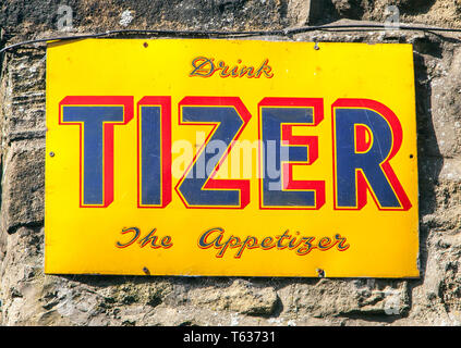 Old metal advertisement for Tizer Stock Photo - Alamy