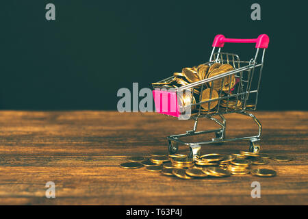 Step of coins stacks with notebook laptop computer and financial graph ...