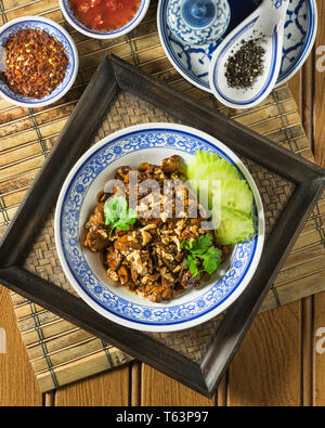 Thai food Fried Pork with Garlic and Thai peppers decorate with carved ...