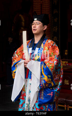 Taoist priest praying at the Temple of the Town Gods (or Temple of the ...