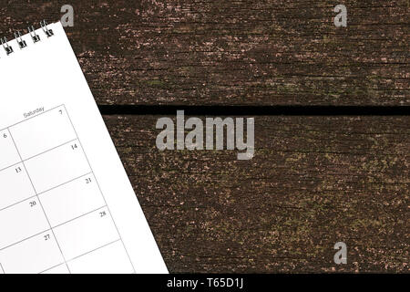 Calendar or planner on dark wood background with copy space. Business ...