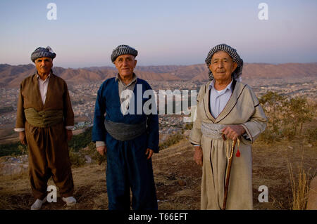 Kurdish men wearing traditional clothes take in the view of Dohuk ...