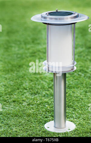 Solar-powered lamp on green grass background. Selective focus Stock ...