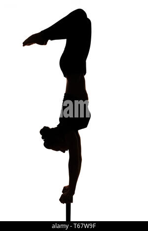 one woman contortionist practicing gymnastic yoga in silhouette on ...