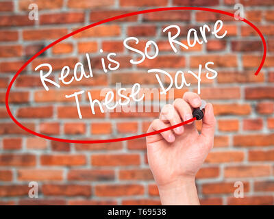 Man Hand writing Real is So Rare These Days with black marker on visual ...