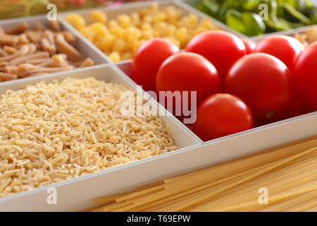 Boxes with different uncooked pasta and products, closeup Stock Photo ...