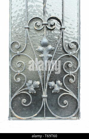 Round window with wrought iron lattice on whitewashed facade in Ronda ...