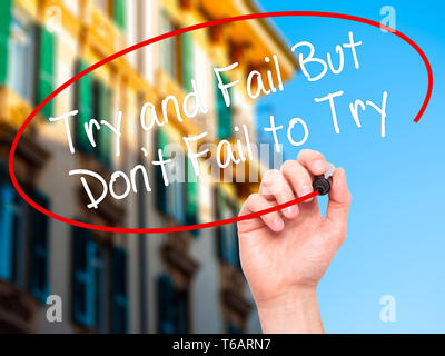 Man Hand writing Try and Fail But Don't Fail to Try with black marker ...