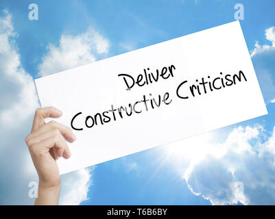 Deliver Constructive Criticism Sign on white paper. Man Hand Holding ...