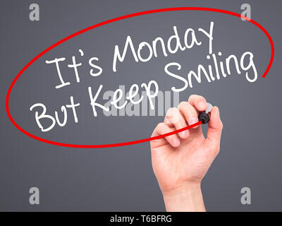 Man Hand writing It's Monday But Keep Smiling with black marker on ...