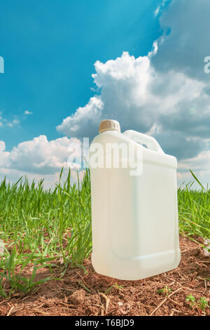 Blank pesticide jug container mock up in wheatgrass field. Using ...