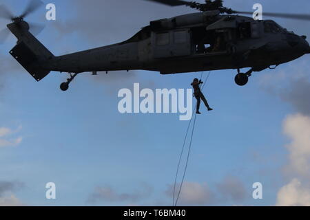 A U.S. Navy Sailor assigned to Explosive Ordnance Disposal Group One ...