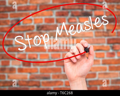 Man Hand writing Stop Measles with black marker on visual screen ...