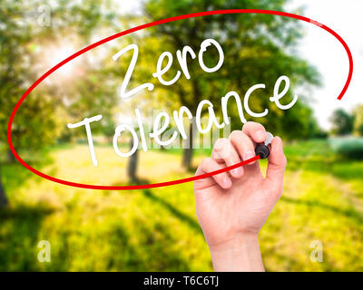 Man Hand writing Zero Tolerance with black marker on visual screen ...