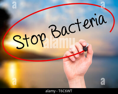 Man Hand writing Stop Bacteria with black marker on visual screen ...