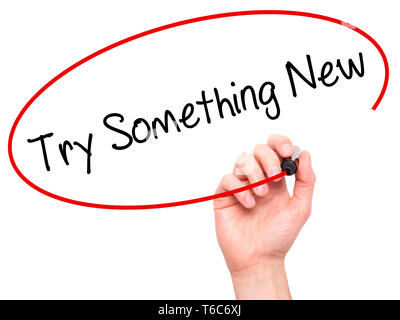 Man Hand writing Try Something New with black marker on visual screen ...