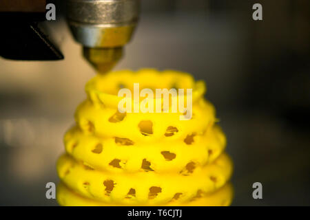 3d printer printing objects yellow form closeup. Modern technical 3D ...