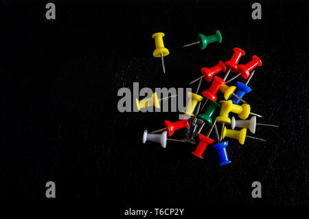 colorful thumbtacks on black background Stock Photo - Alamy