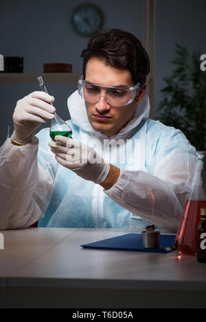 Forensic investigator working in lab looking for evidence Stock Photo ...