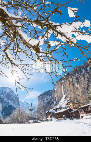 Lauterbrunnen village church and Staubbach Falls cascading down the ...