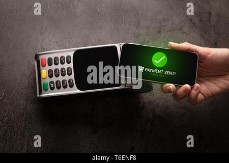 Mobile payment accepted on terminal Stock Photo - Alamy