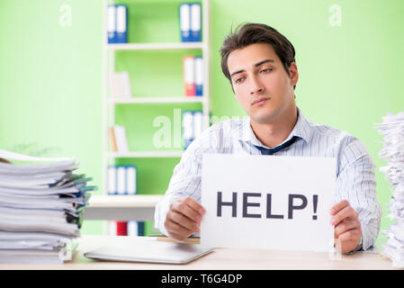 The businessman having problems with paperwork and workload Stock Photo ...