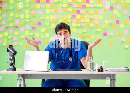 Young doctor with many reminders and urgent work Stock Photo - Alamy