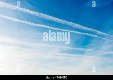 Blue sky with many contrails or chemtrails Stock Photo - Alamy