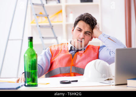 Drunk engineer working in the workshop Stock Photo - Alamy